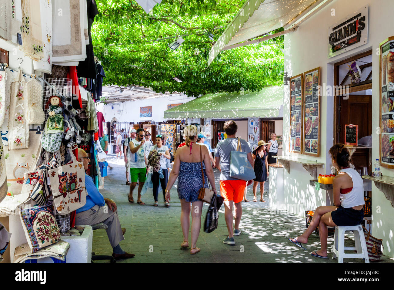 Tourists Walking Through The Streets Of Lindos Town, Rhodes, Greece ...