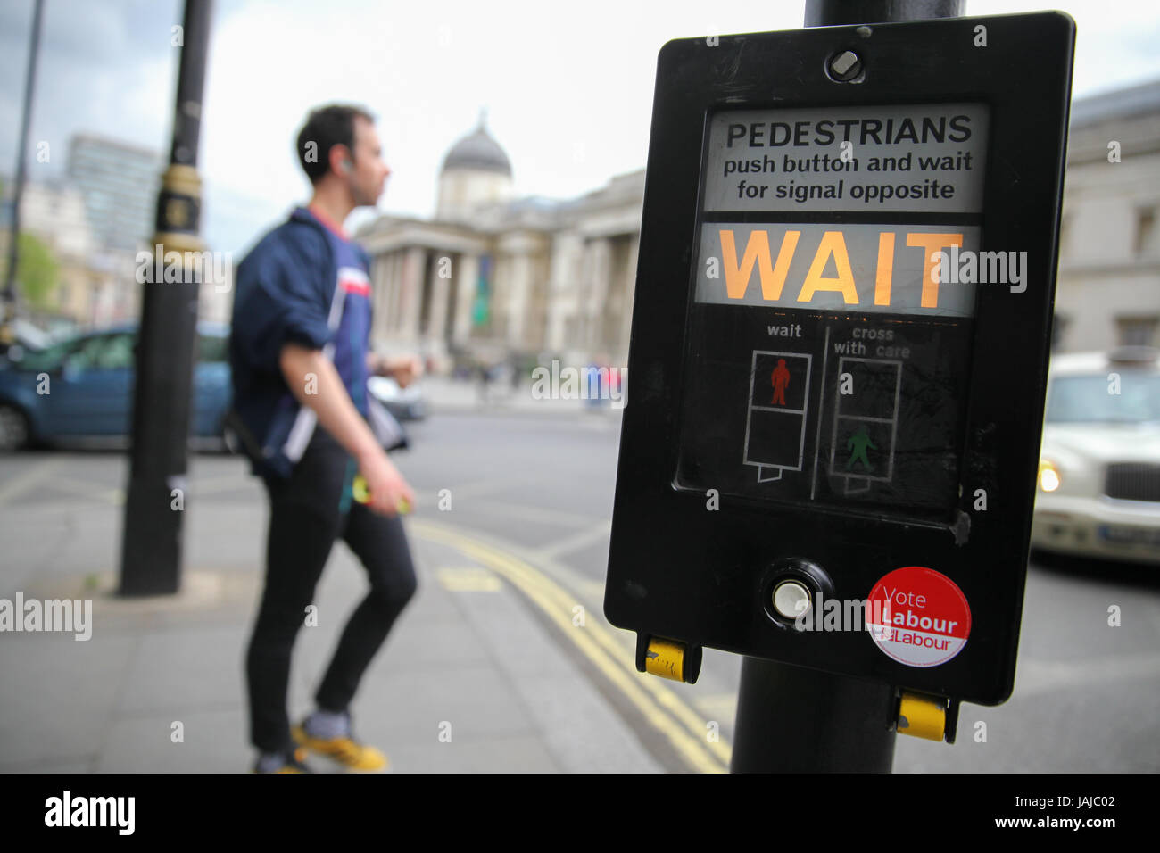 A 'Vote Labour' sticker on a pedestrian crossing machine Featuring ...
