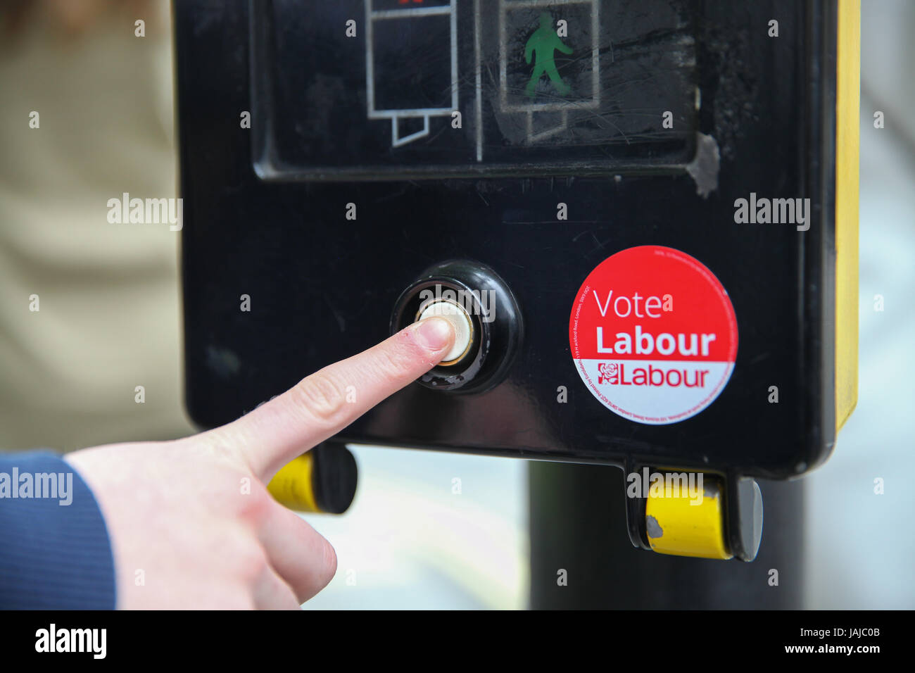 A 'Vote Labour' sticker on a pedestrian crossing machine Featuring ...