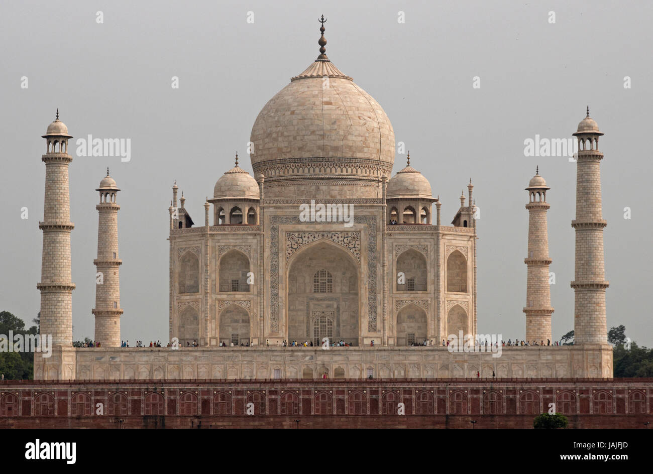 Taj Mahal. White marble tomb set on raised platform topped by large ...