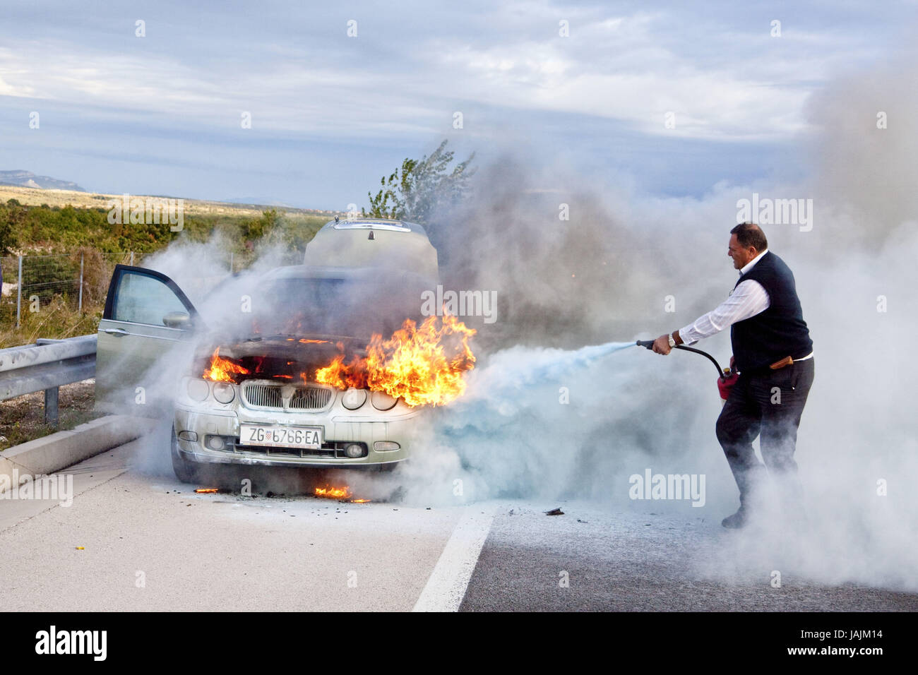 Croatia,burning car by the roadside,man with fire extinguisher Stock ...