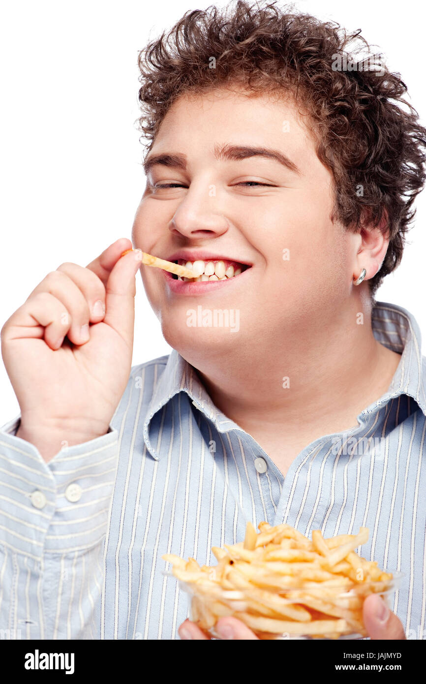 Happy young chubby man with french fries in dish, isolate on white ...