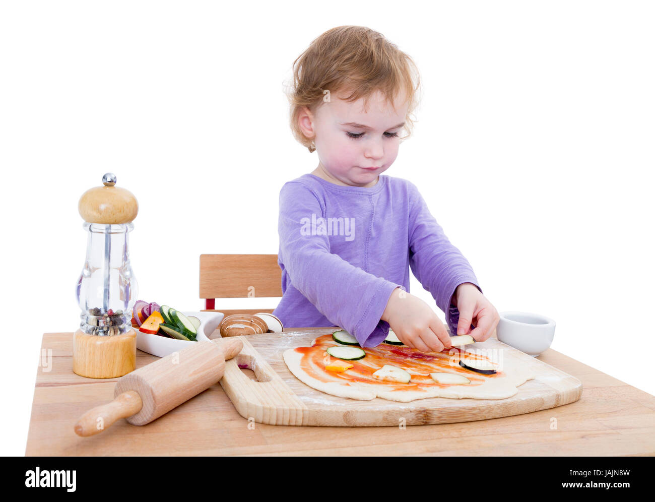 cute girl making pizza isolated in white background Stock Photo - Alamy