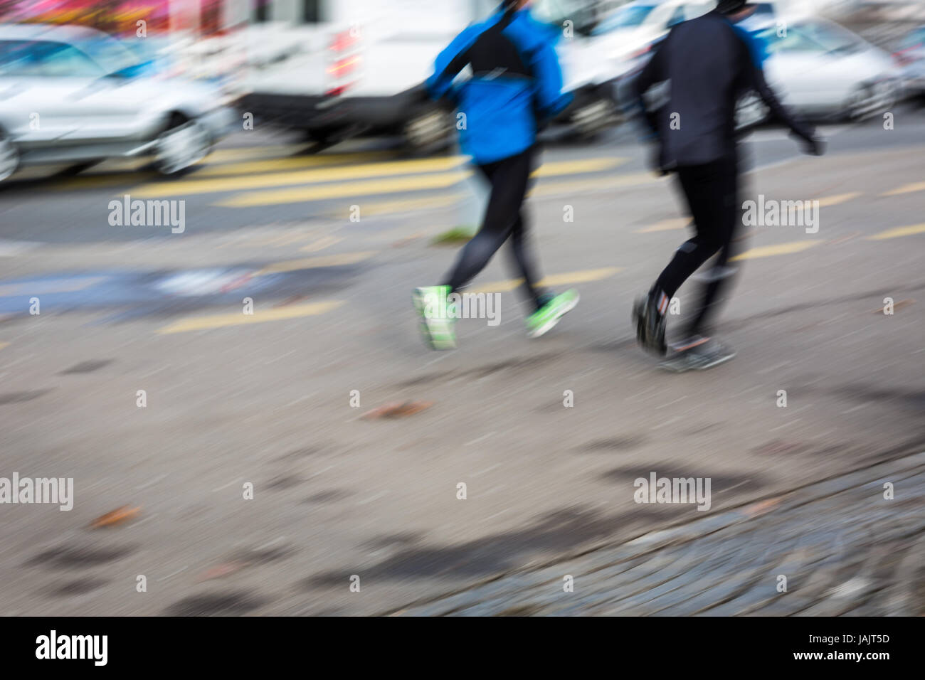 Two male runners in an urban context (panning technique used -> motion ...
