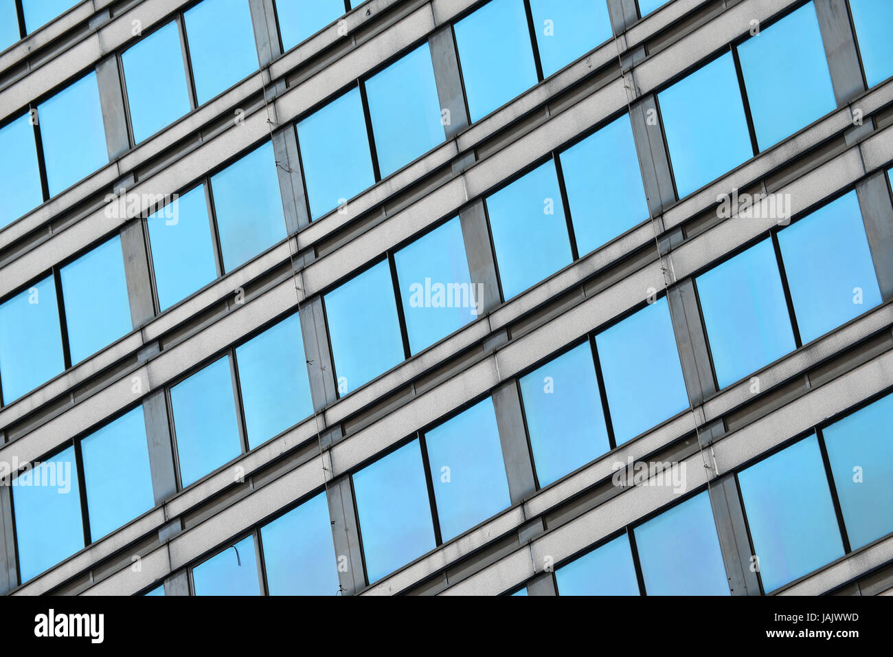 Blue glass windows of modern business office building, diagonal ...