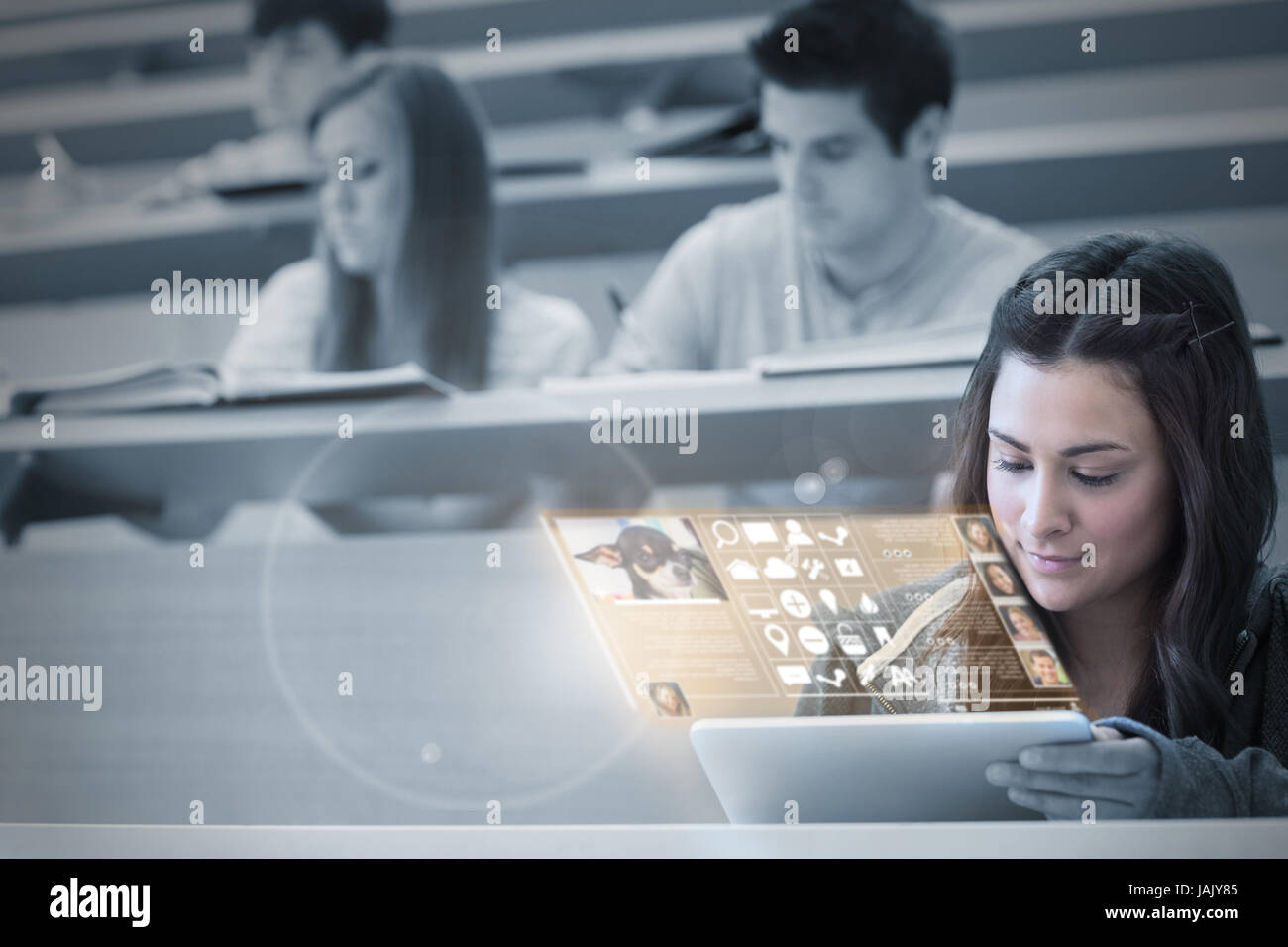 Serious student working on her futuristic tablet in lecture hall Stock ...