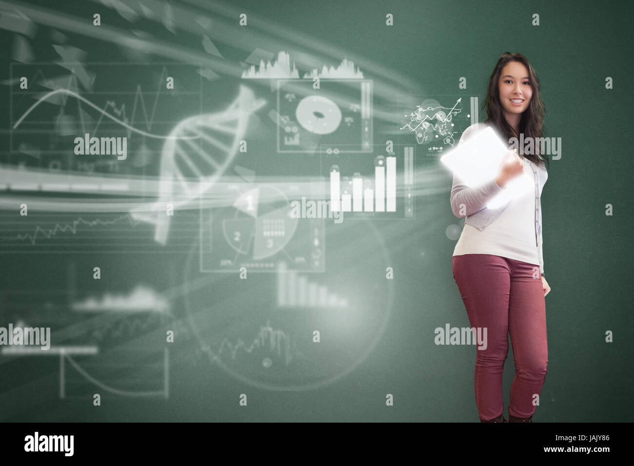 Smiling student posing on digital background with diagrams and charts ...