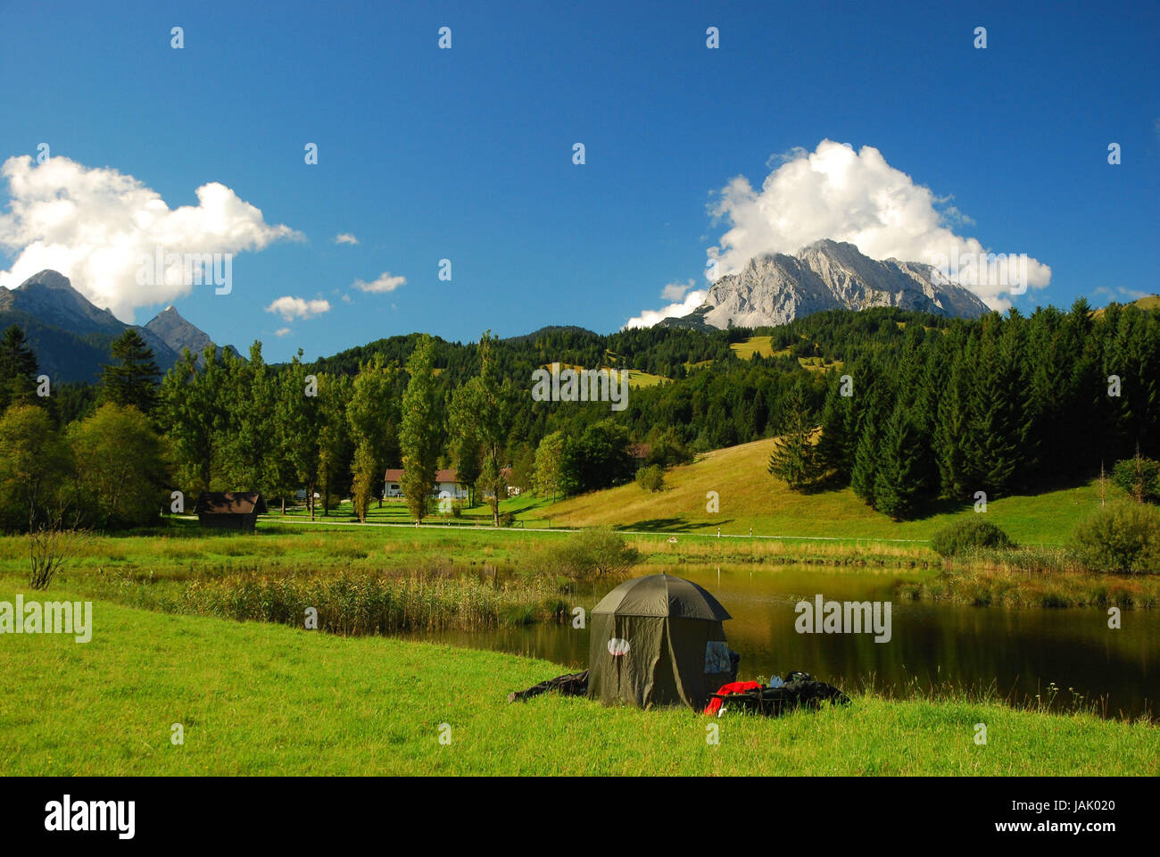 Germany,Bavaria,Mittenwald,Isar valley,narrow lake,reed shore,angler ...