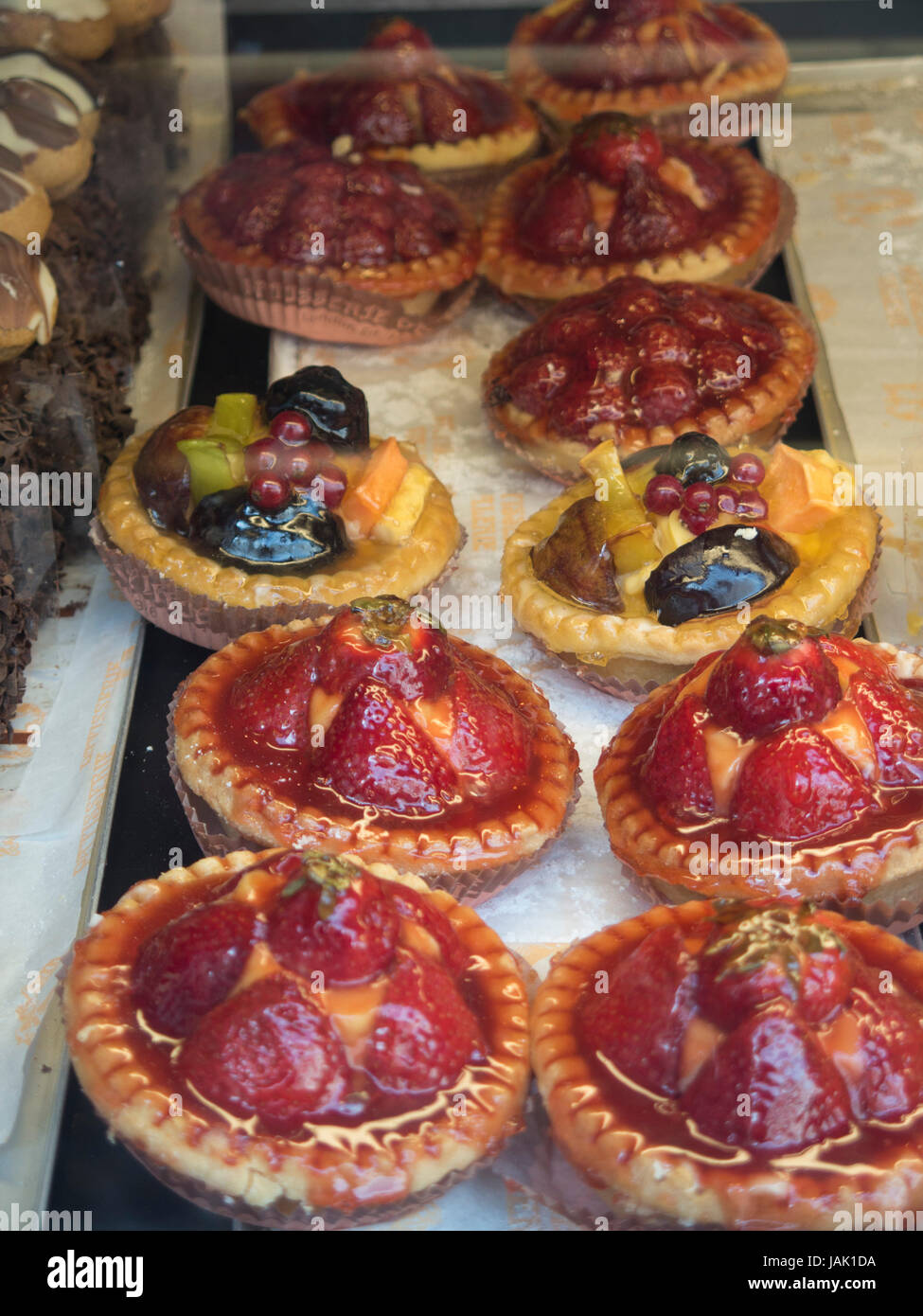 Pastries for sale in shop window Stock Photo - Alamy