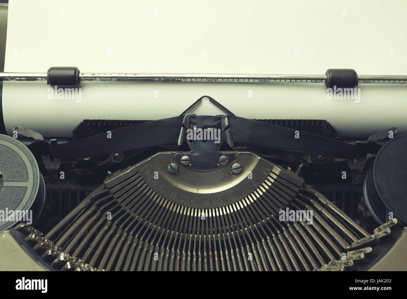 Old, well-worn typewriter on a black wooden background. Sheet of paper ...