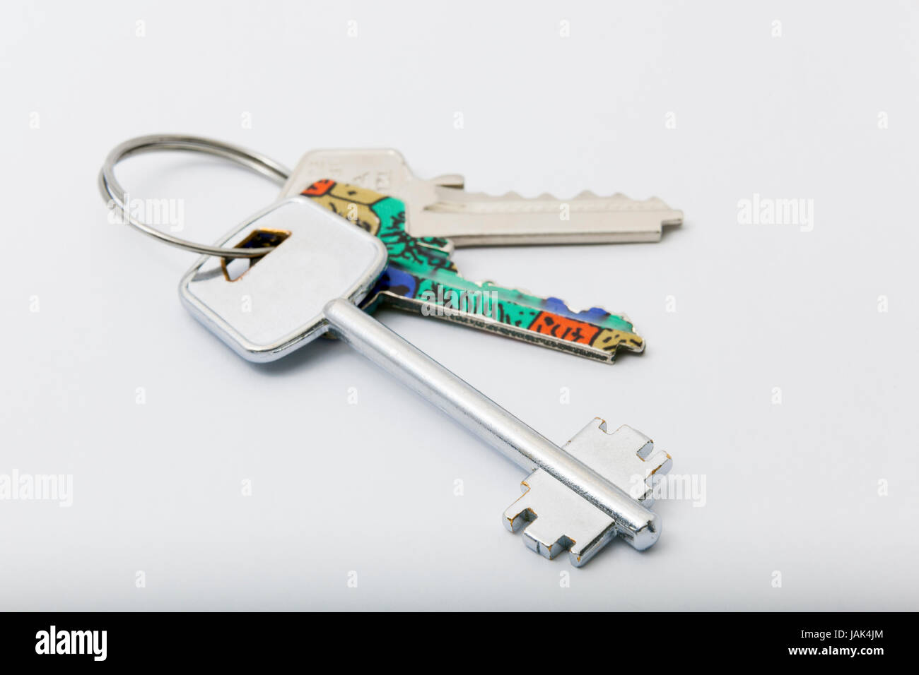 Three keys in white background Stock Photo - Alamy