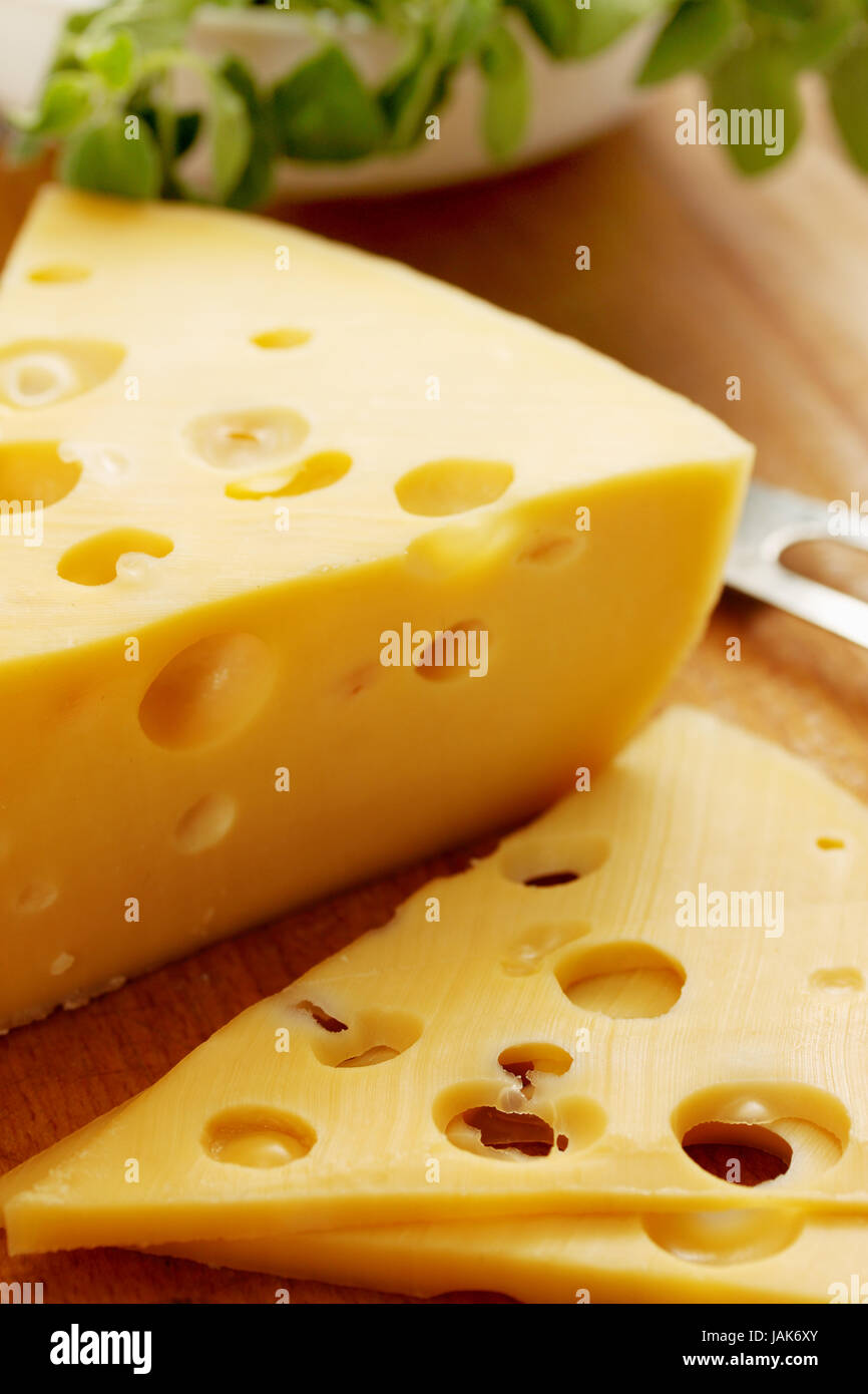 A thin slice of cheese cut from the large chunk of Swiss Syrah Stock ...