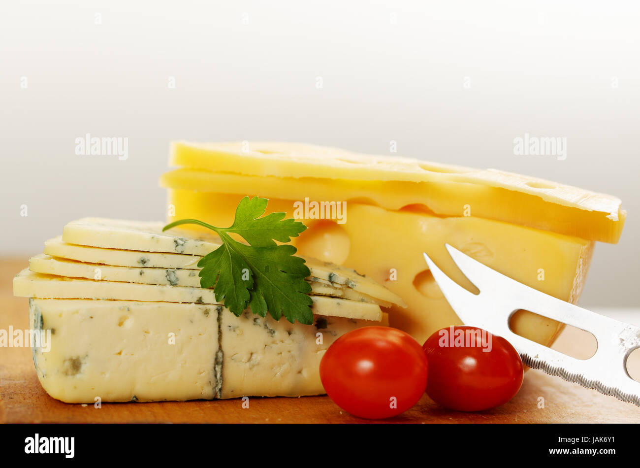blue cheese and Swiss cheese with cherry tomatoes Stock Photo - Alamy