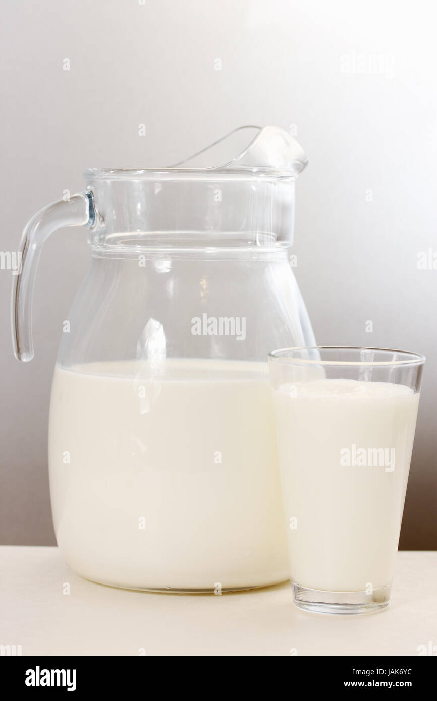 transparent decanter and glass filled with milk Stock Photo - Alamy
