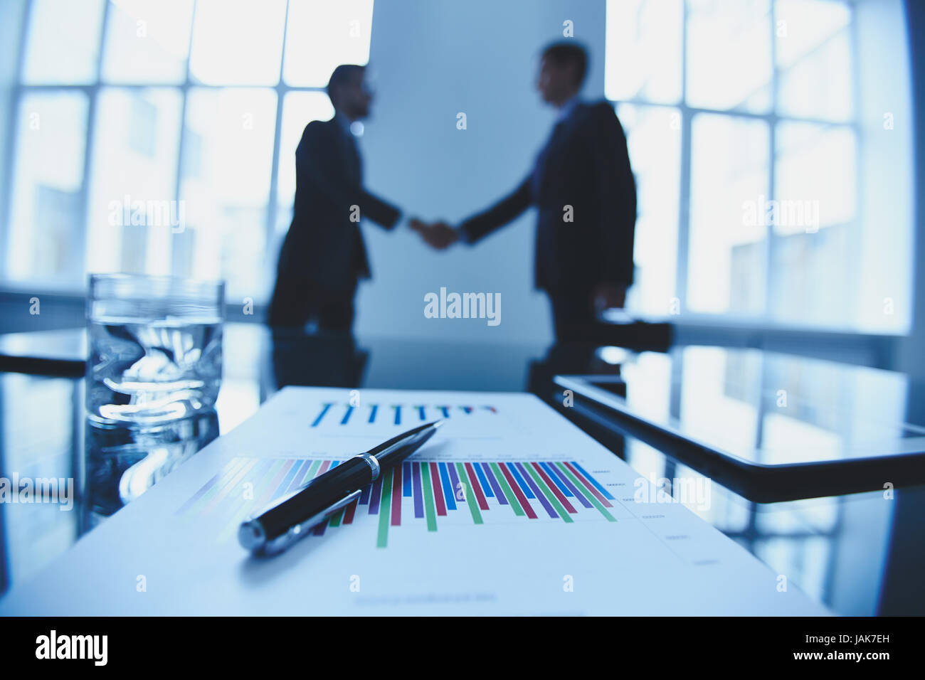 Close-up of business objects at workplace on background of partners ...