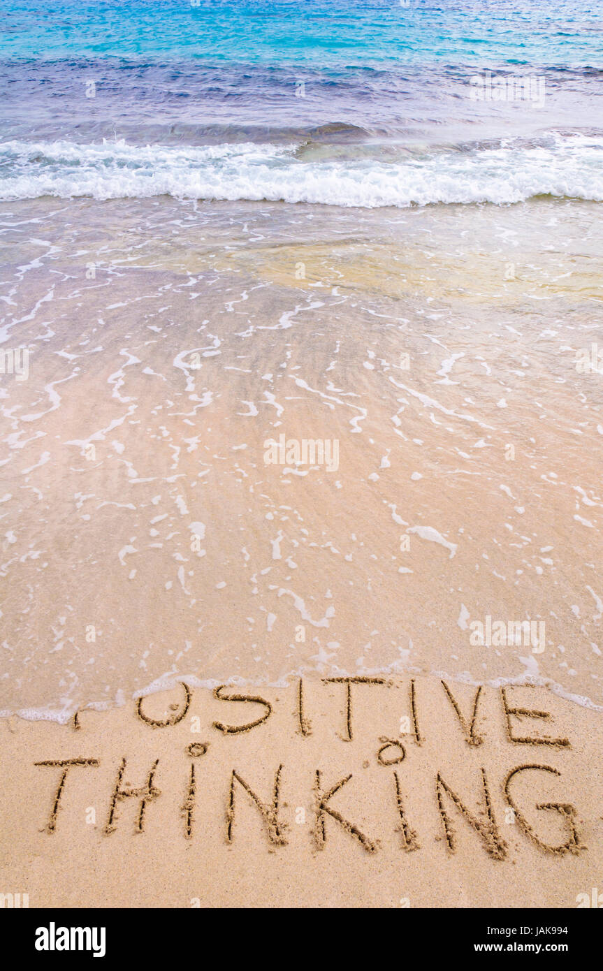 Positive Thinking message written on sand, with waves in background ...