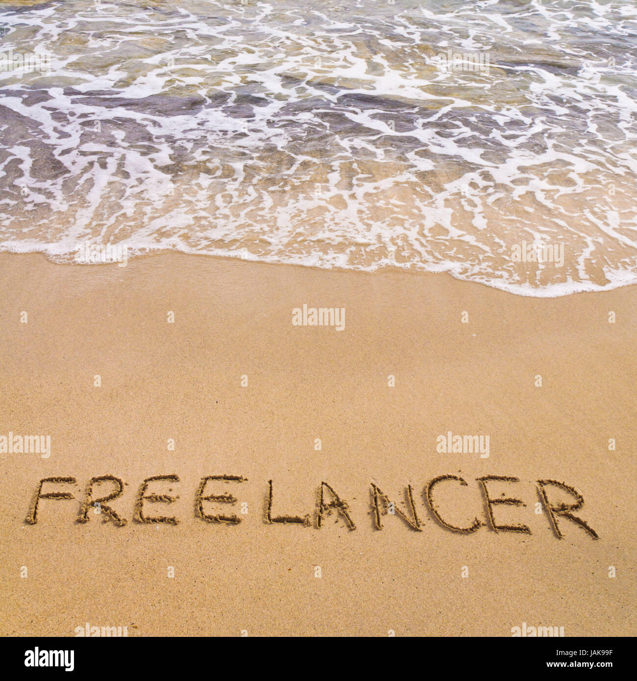 Word FREELANCER written in sand, on a beautiful beach, Freelance ...