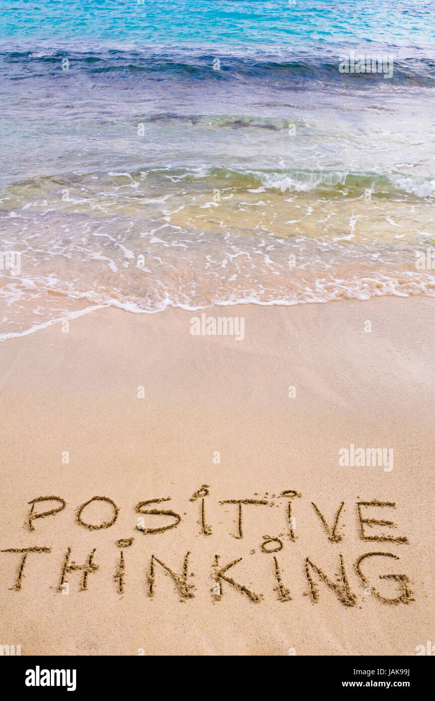 Positive Thinking message written on sand, with waves in background ...