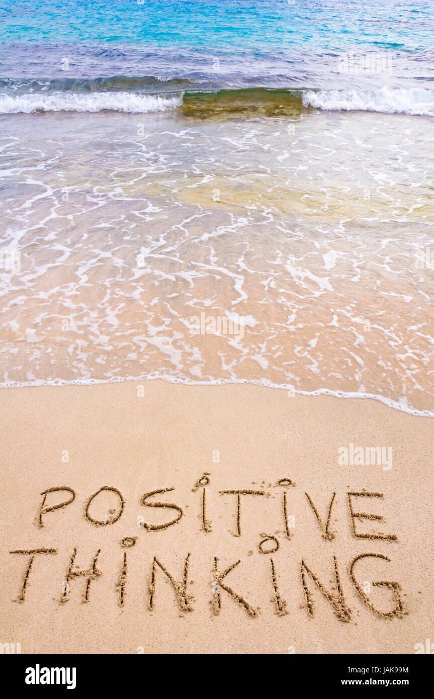 Positive Thinking message written on sand, with waves in background ...