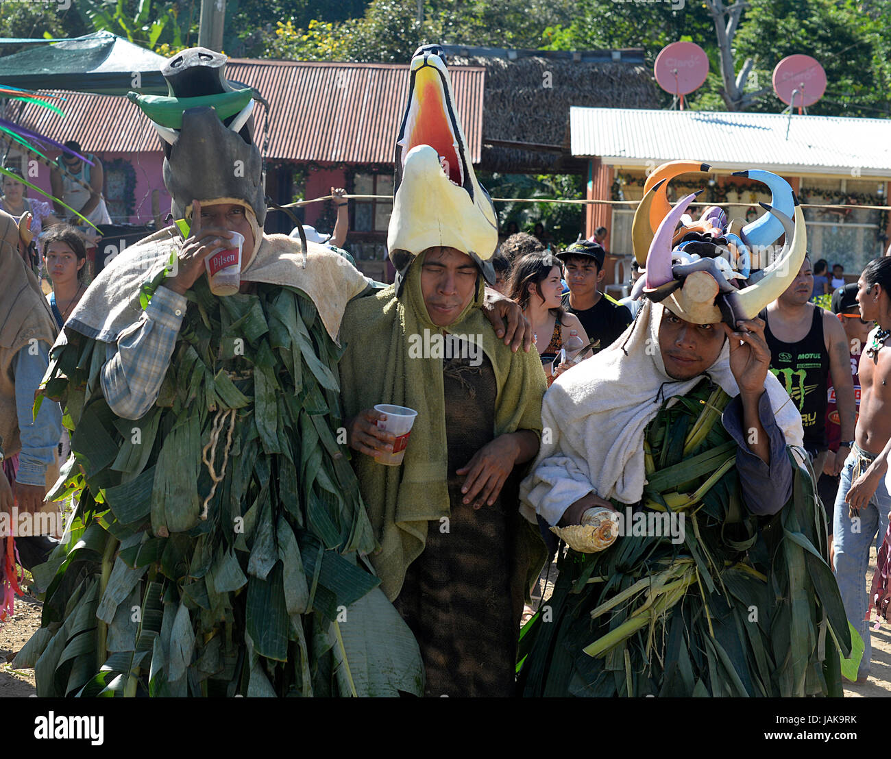 A group of devils lift their masks to down some beer before the next ...