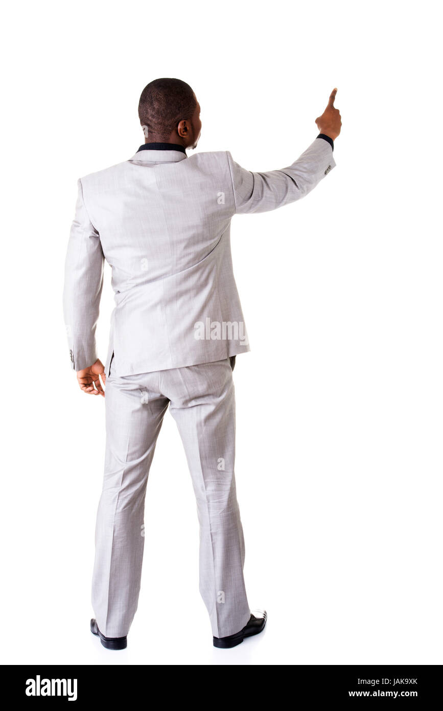 Young businessman pointing on copy space. back view. Isolated on white ...