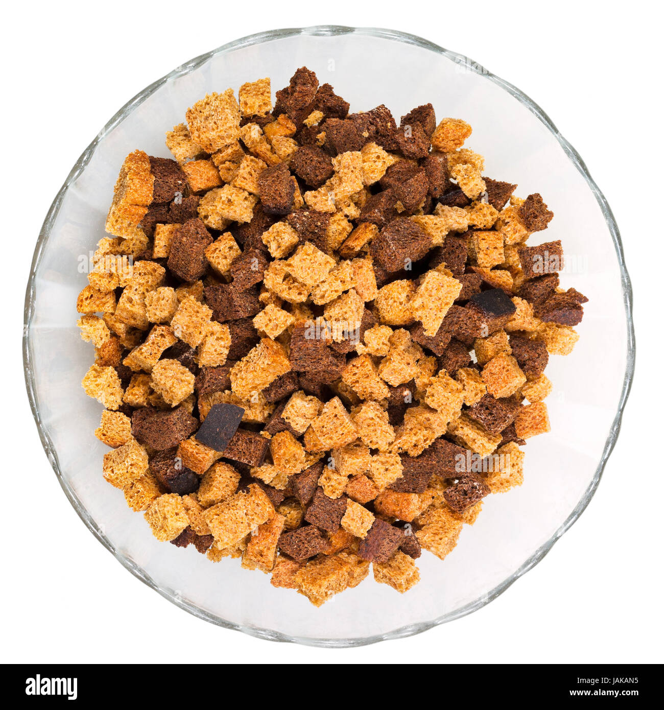 top view of dried rye bread pieces in glass bowl isolated on white ...