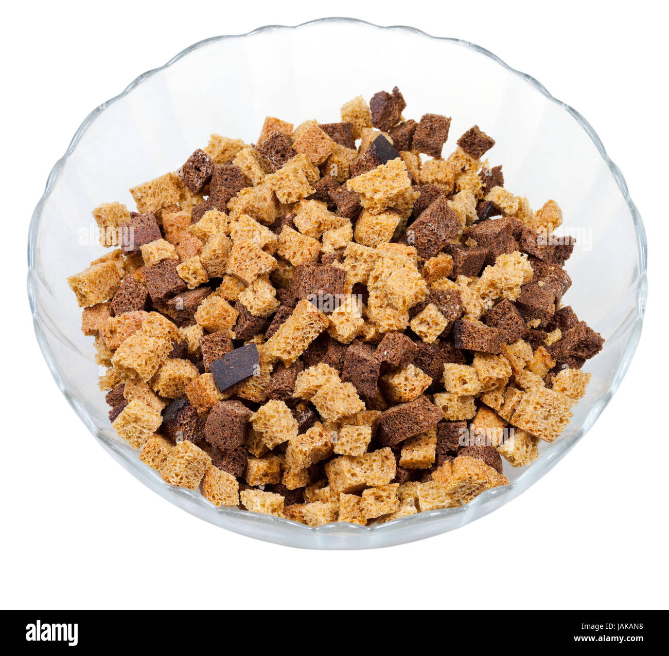 dried rye bread crust pieces in glass bowl isolated on white background ...