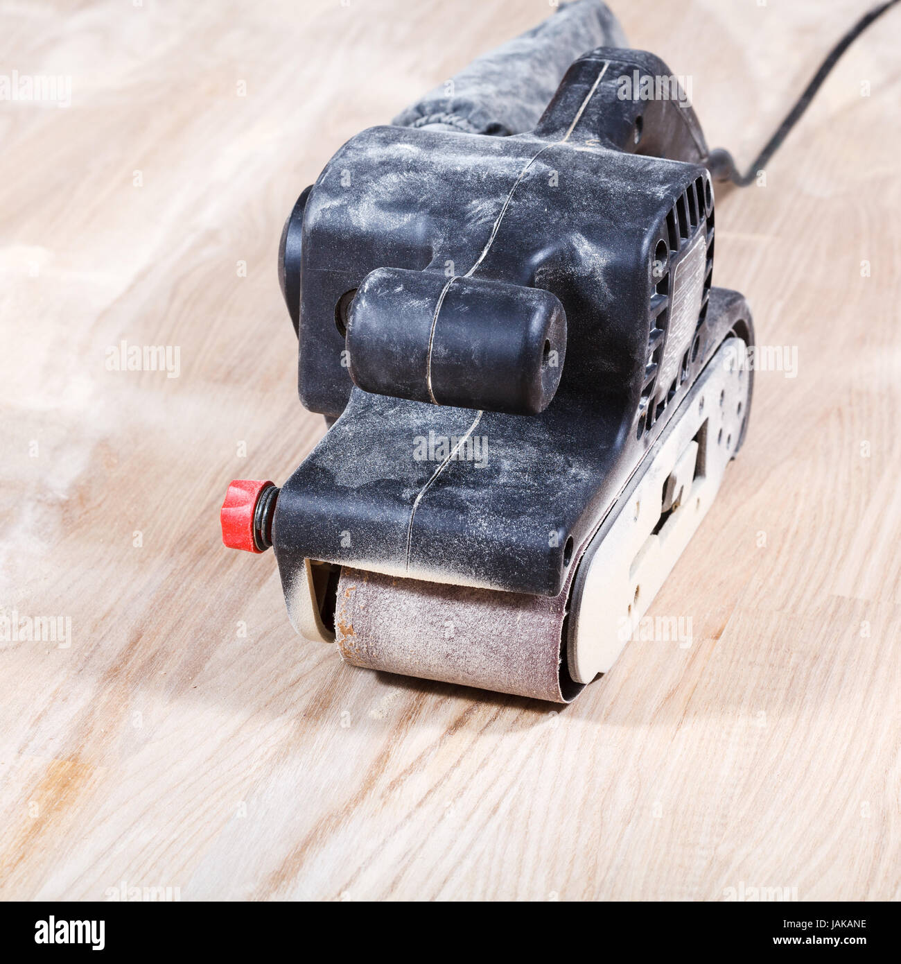 hand-held belt sander finishing ashwood surface Stock Photo - Alamy