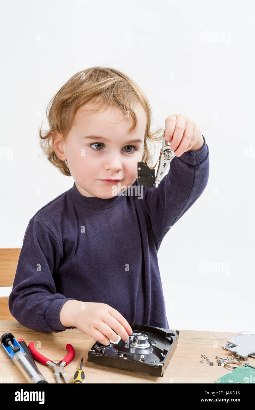 young child repairing open hard disk drive with different tools Stock ...