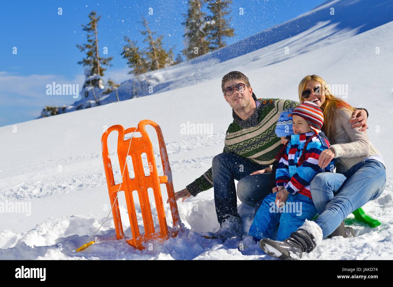 Winter season. Happy family having fun on fresh snow on vacation Stock ...