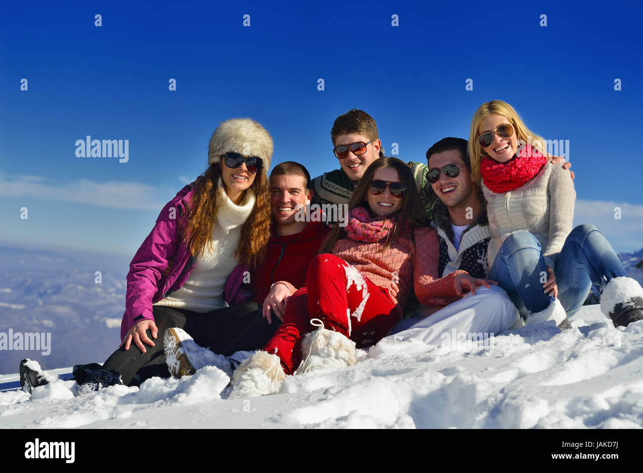 happy friends have fun at winter on fresh snow, healthy young people ...