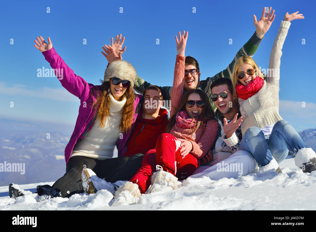 happy friends have fun at winter on fresh snow, healthy young people ...