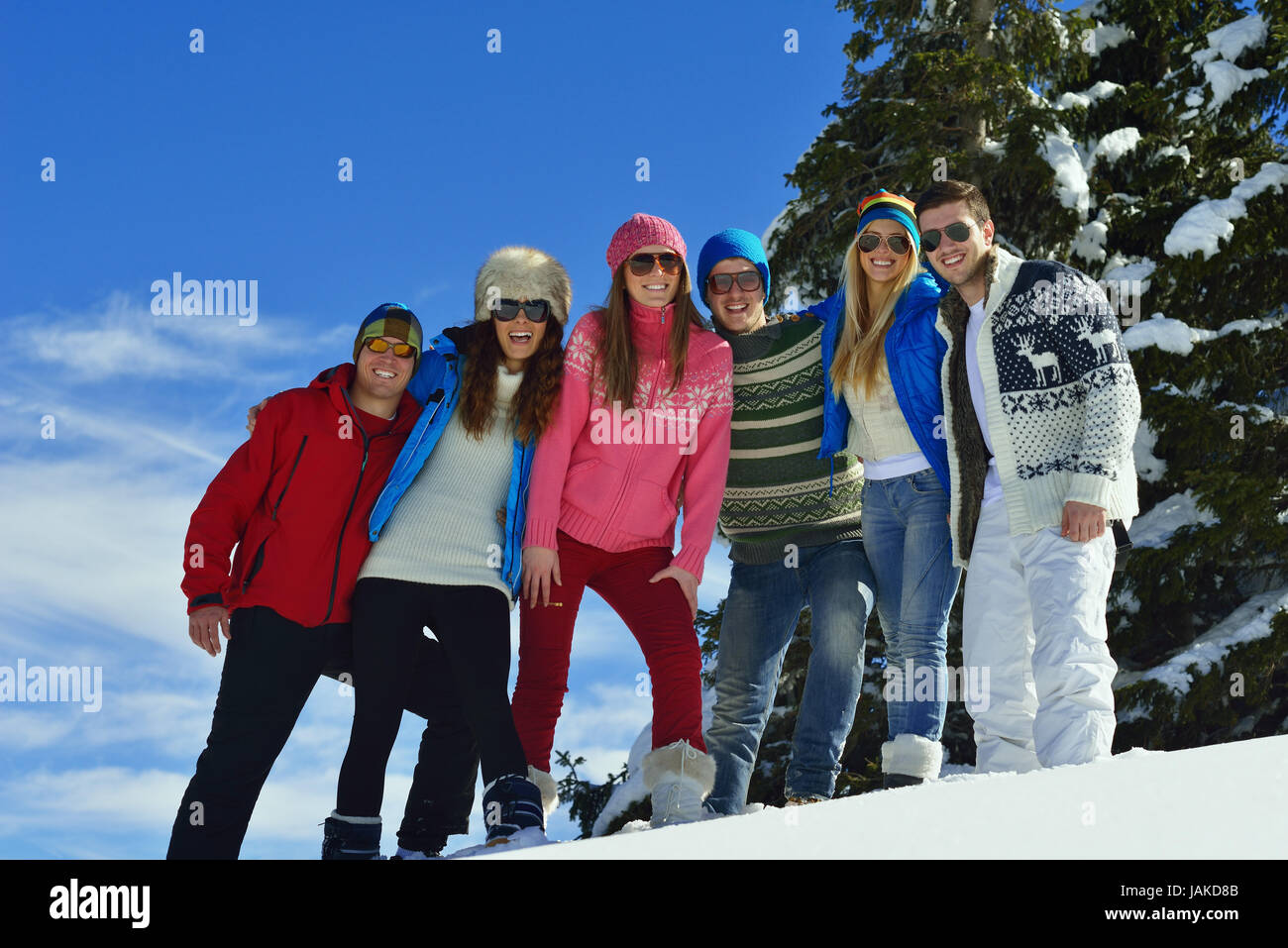 happy friends have fun at winter on fresh snow, healthy young people ...