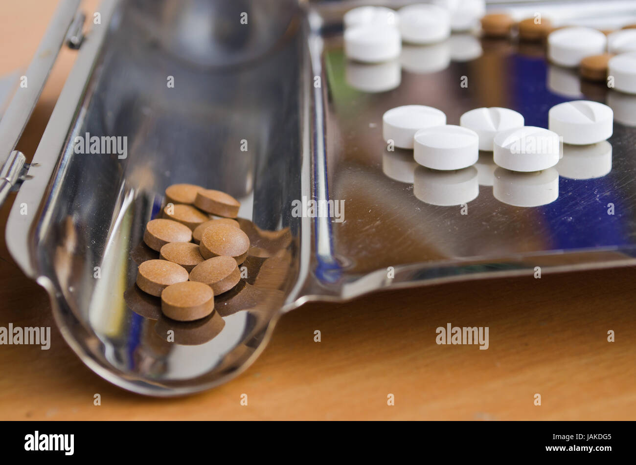 Close up of Counting tablets medical pills on stainless steel tray ...