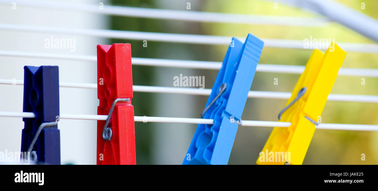 colorful pegs on a drying rack Stock Photo - Alamy