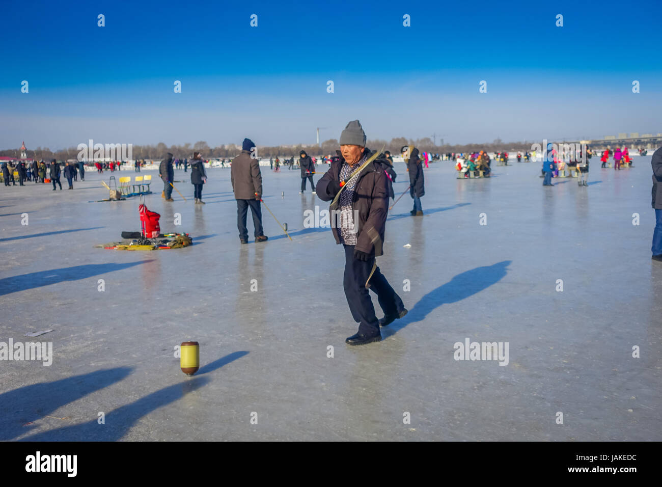 Harbin, China - February 9, 2017: Spinning top on ice on frozen river ...