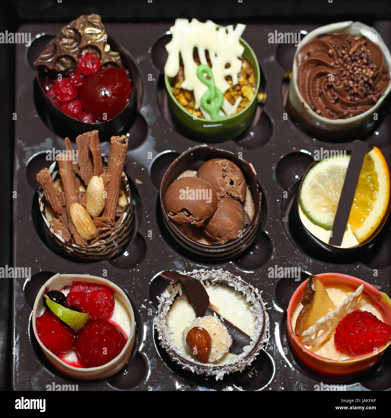 Candy box with nine sweet desserts Stock Photo - Alamy