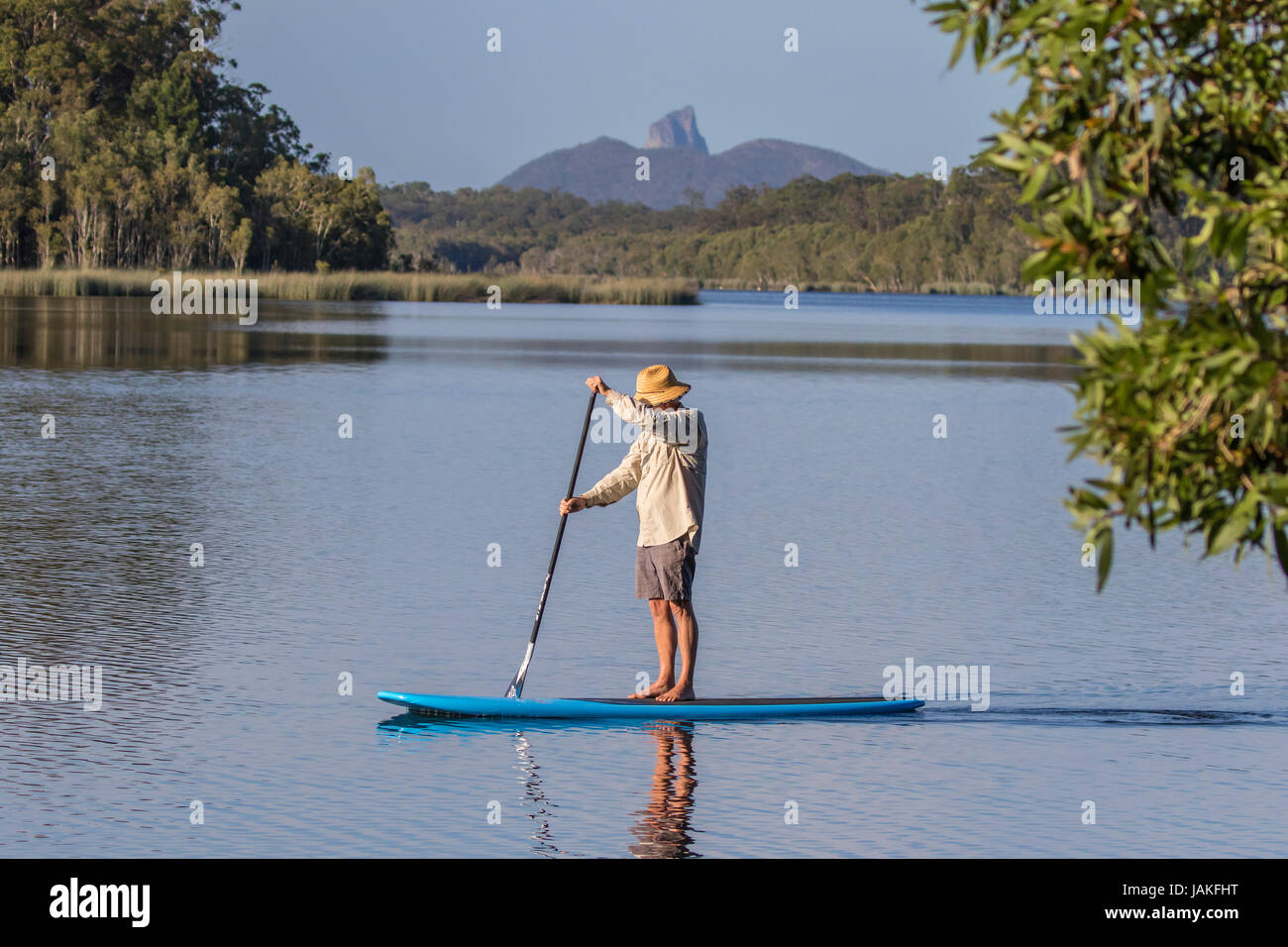 man paddle boarding on Lake Stock Photo - Alamy