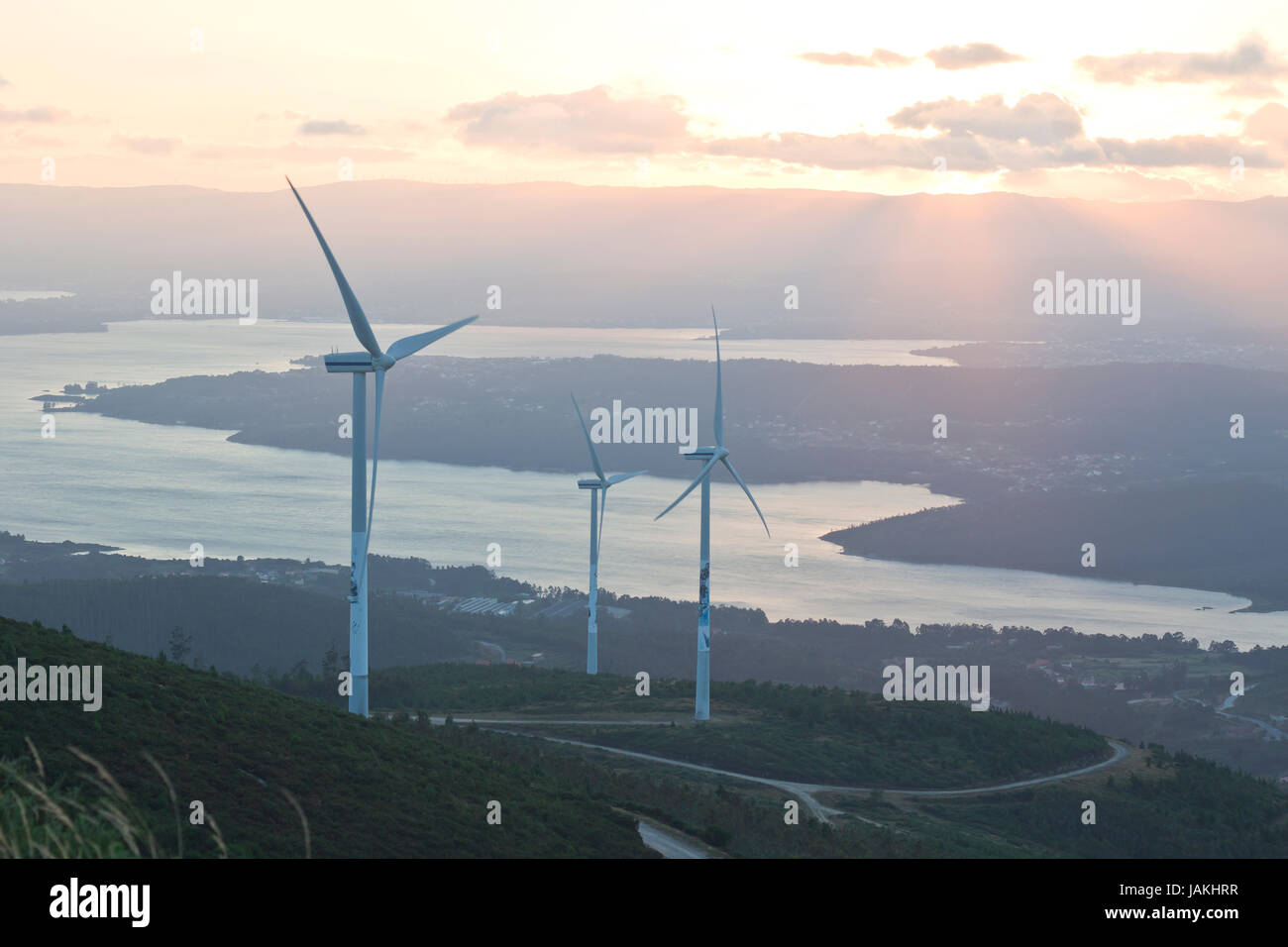 Wind turbines farm with rays of light at sunset Stock Photo - Alamy
