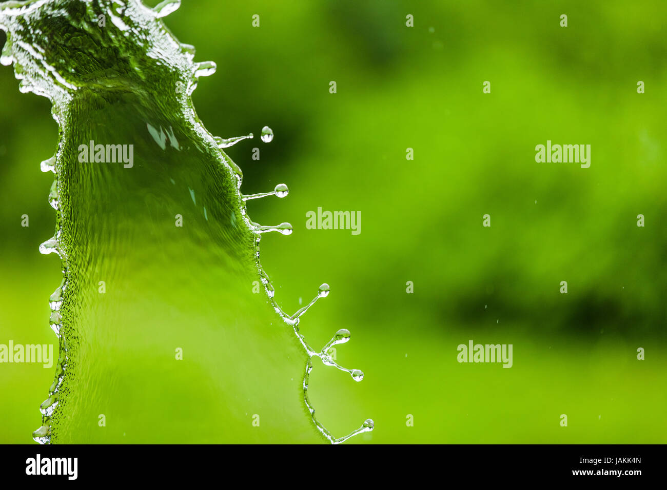Falling Water Splash over Green Abstract Background Stock Photo - Alamy