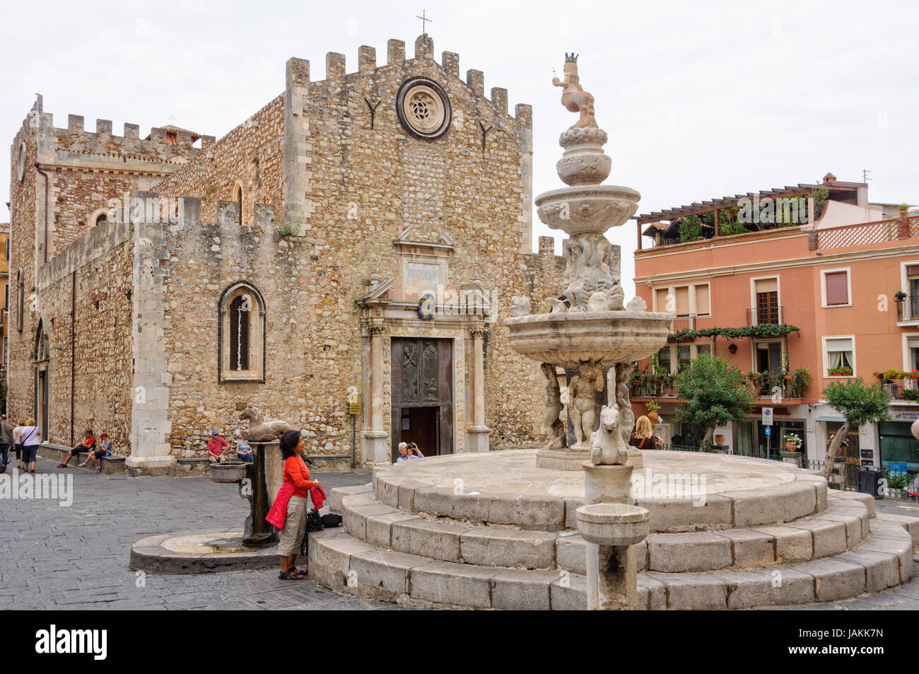 Tourists around the fountain and cathedral on the compact and ...