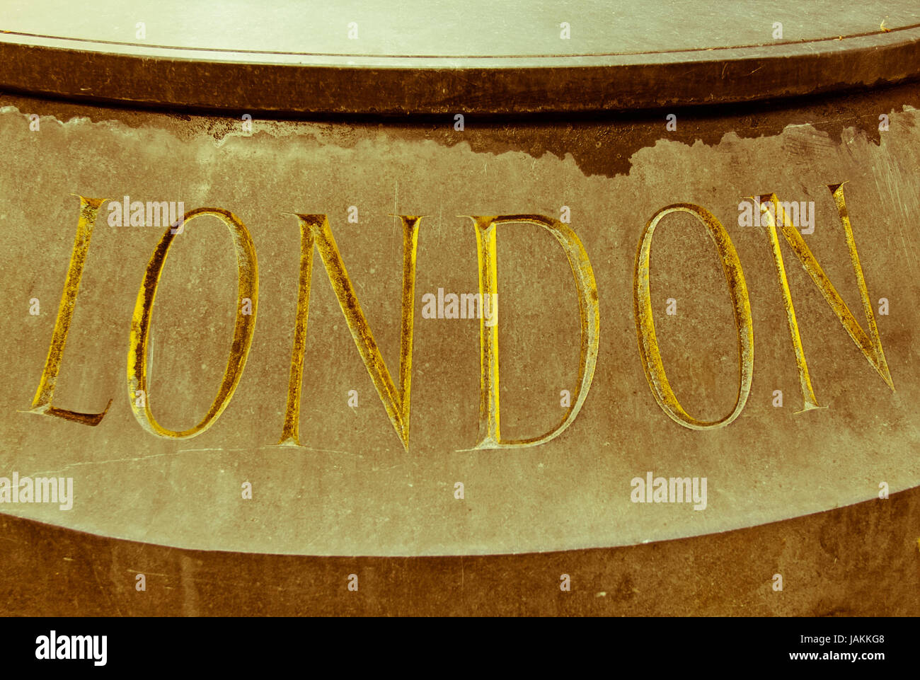 Vintage look London inscription written in golden letters in stone ...