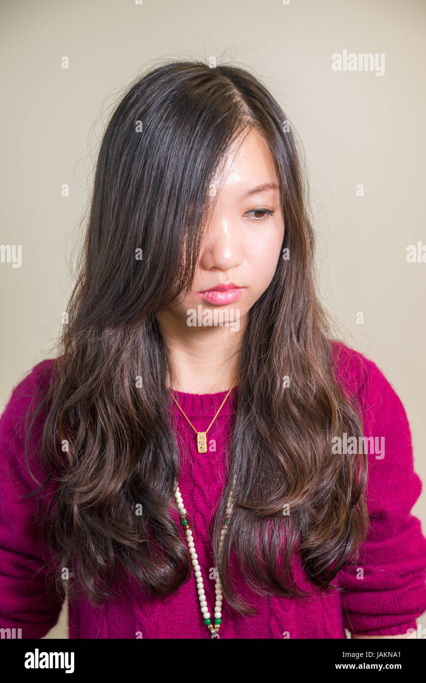 Portrait of young woman looking stressed out Stock Photo - Alamy