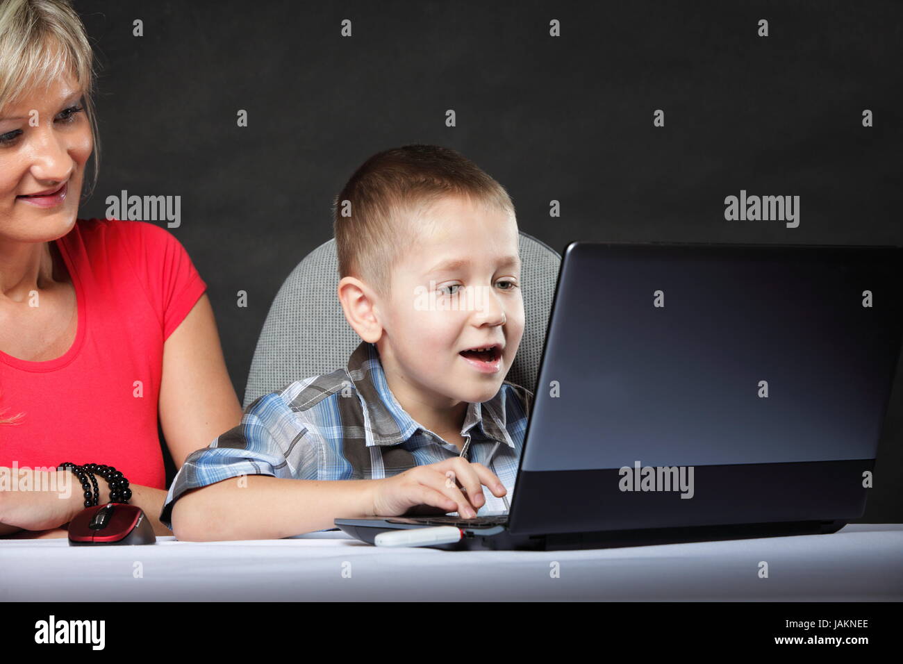 Boy helping mom with pc hi-res stock photography and images - Alamy