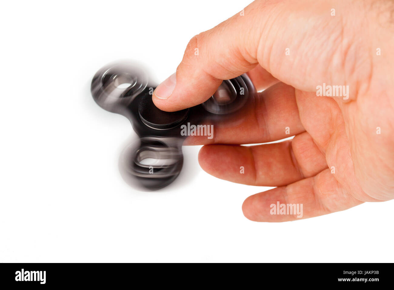 Palying with a Black Fidget Spinner isolated on white background Stock ...