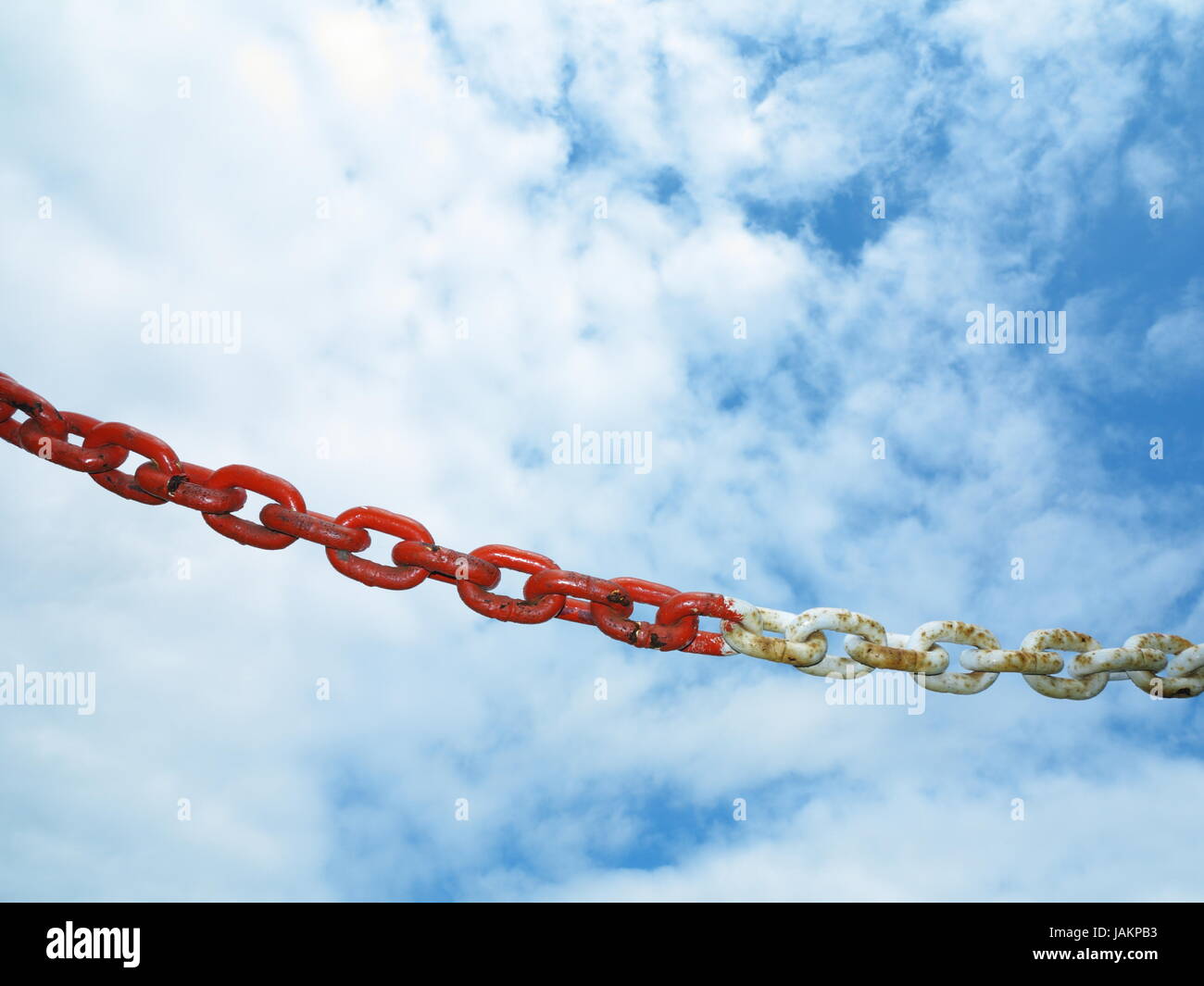 Old rusty metal steel red white chain links segment. Sky cloudy ...