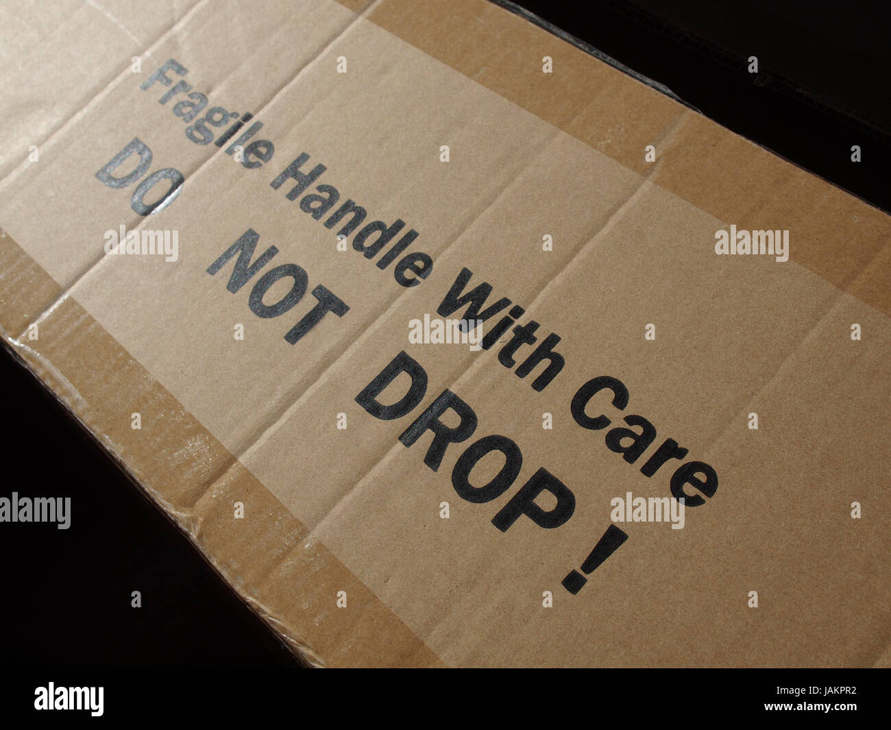 Fragile Handle with Care Do not drop label on a corrugated cardboard box Stock Photo - Alamy