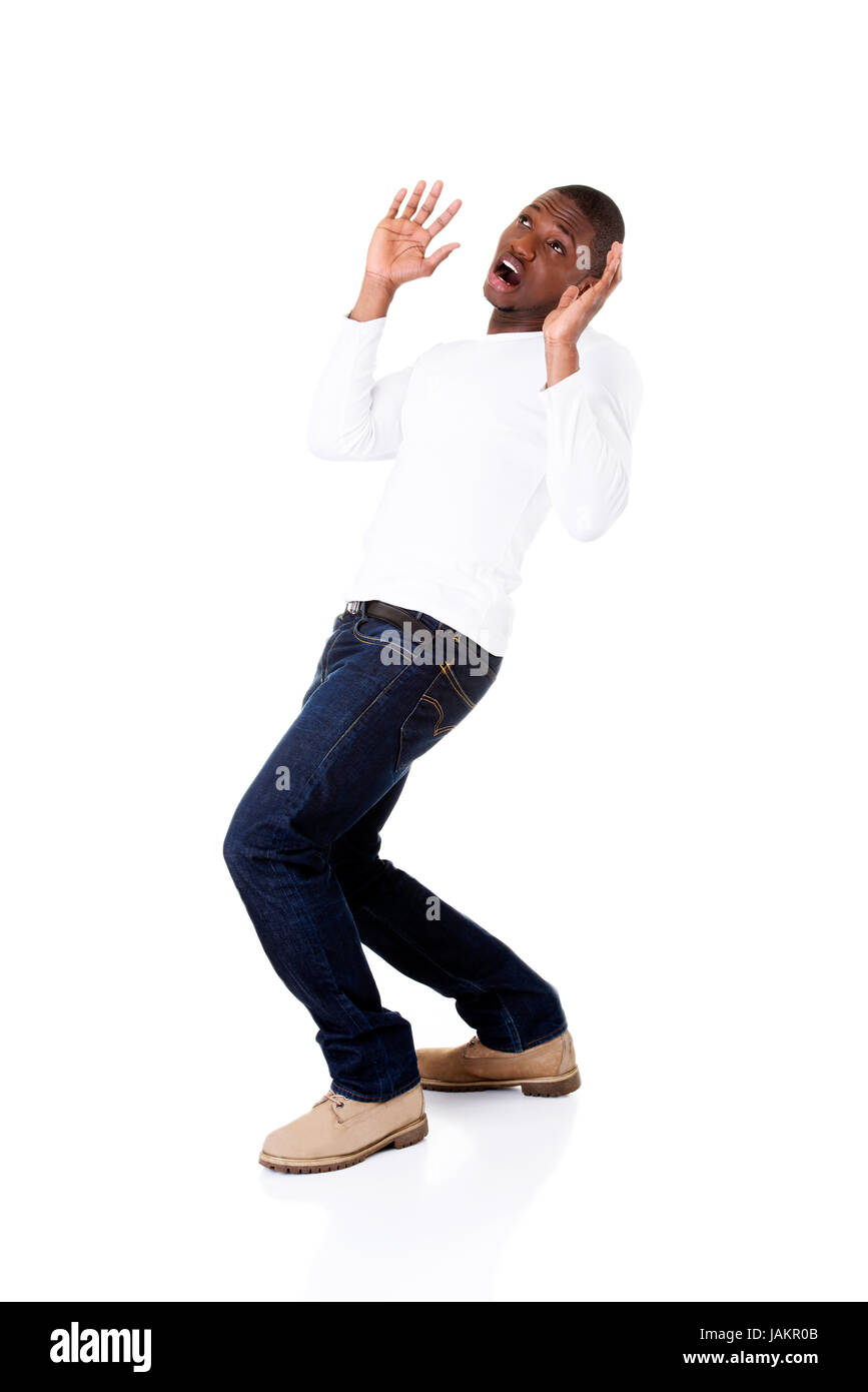Handsome young man standing, scared. Isolated on white Stock Photo - Alamy