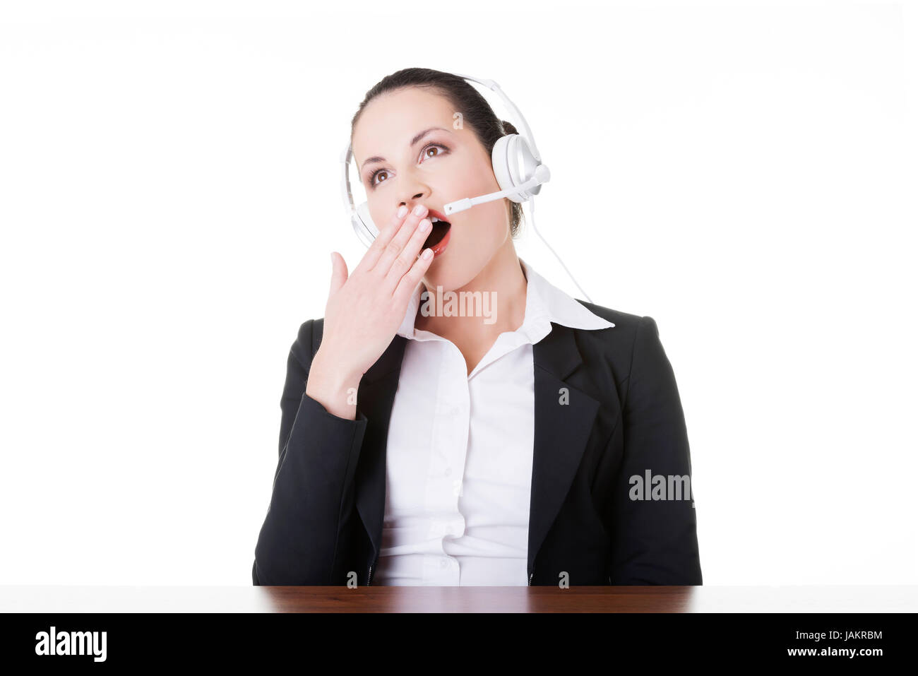 Business woman with headphones yawning. Isolated on white Stock Photo ...