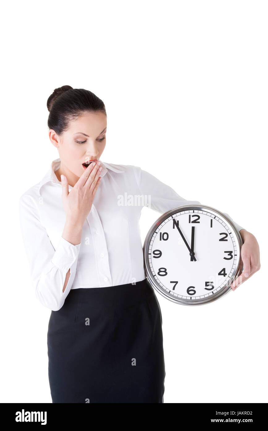 Business woman holding a clock and yeaning. Isolated on white Stock ...